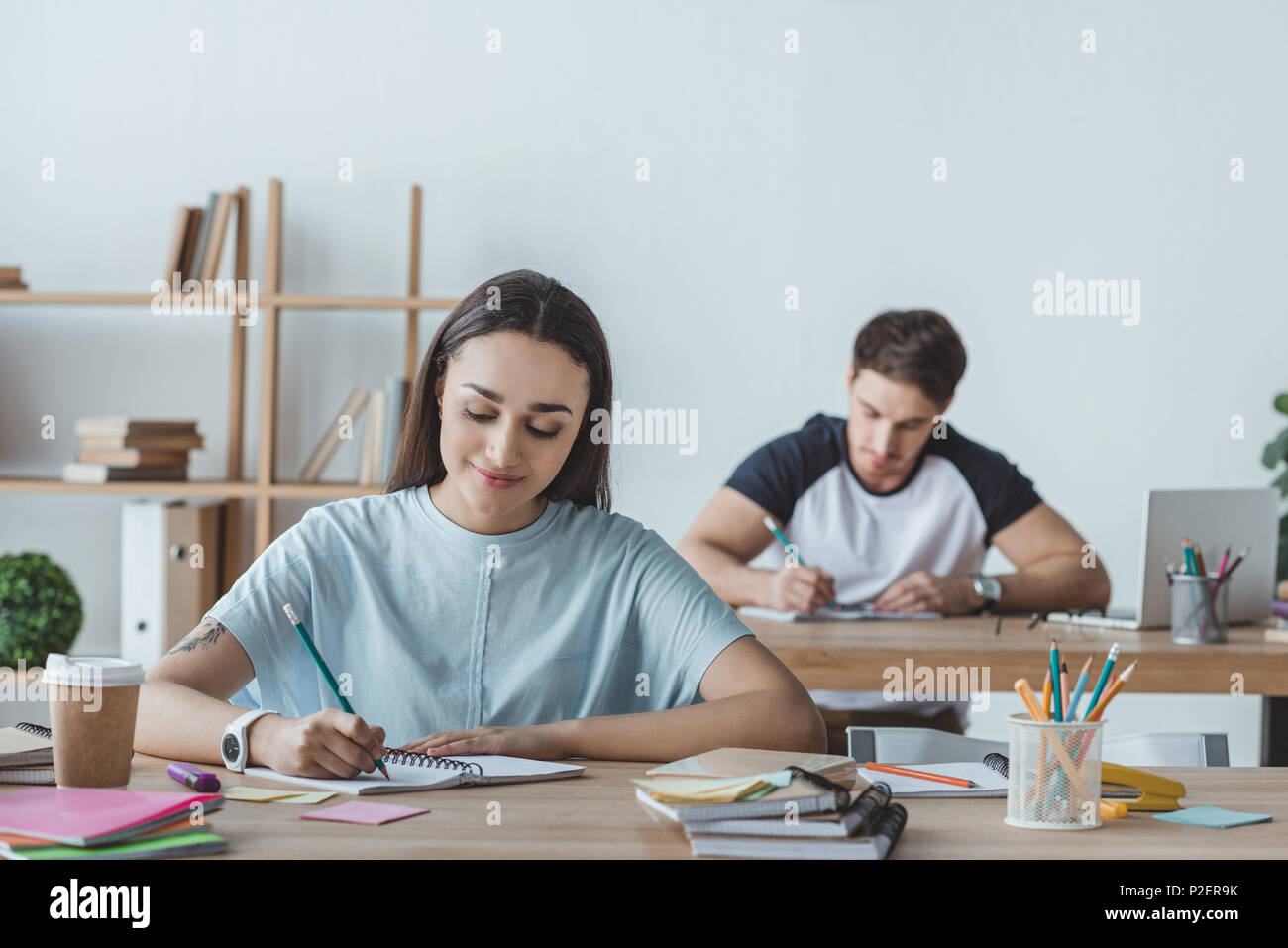 multiethnic students writing exam together Stock Photo - Alamy