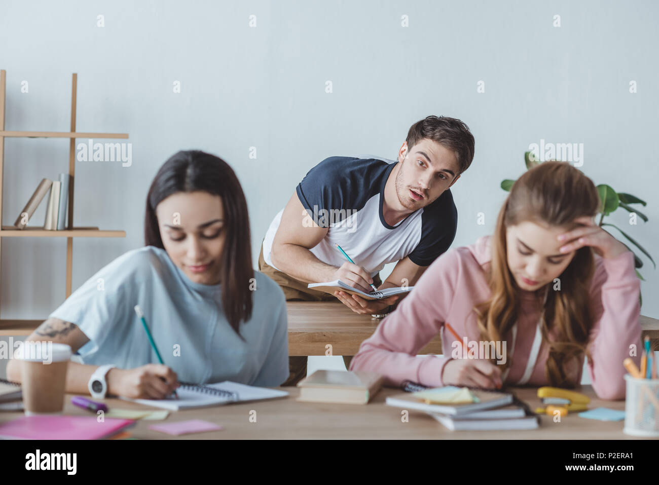 young students writing examination while man writing off Stock Photo ...