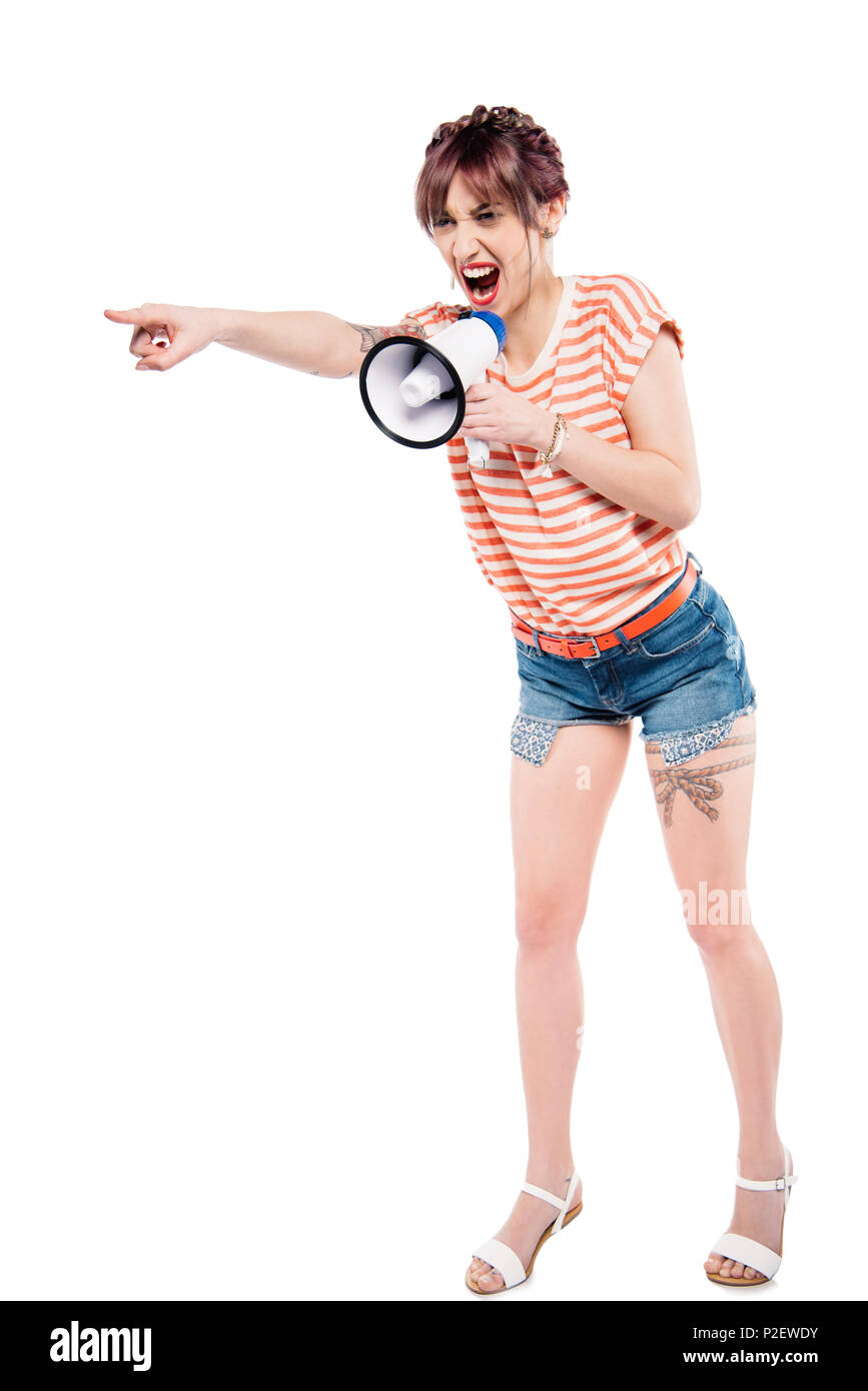 screaming young woman with loudspeaker pointing away isolated on white ...