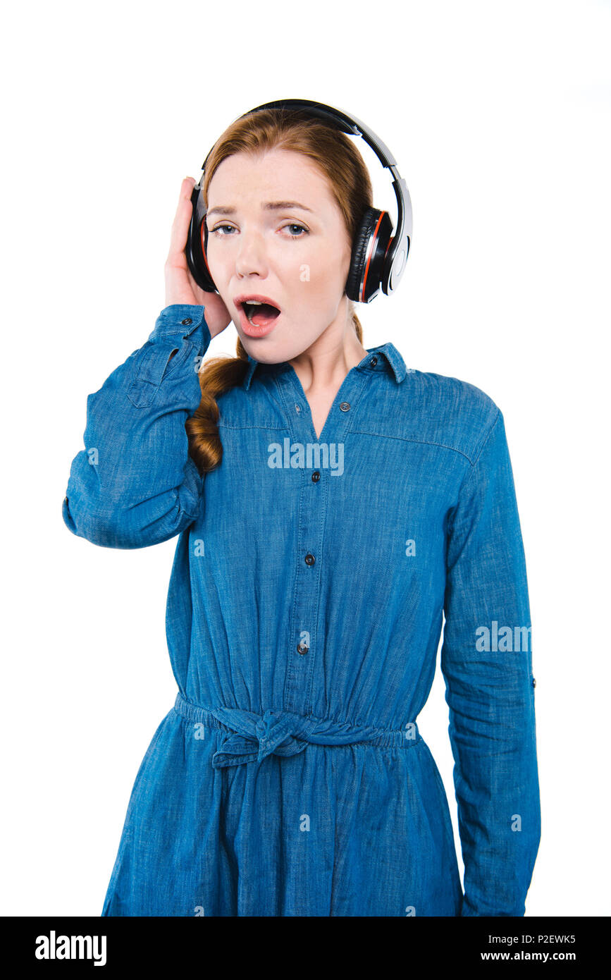 shocked stylish girl listening music with headphones, isolated on white ...