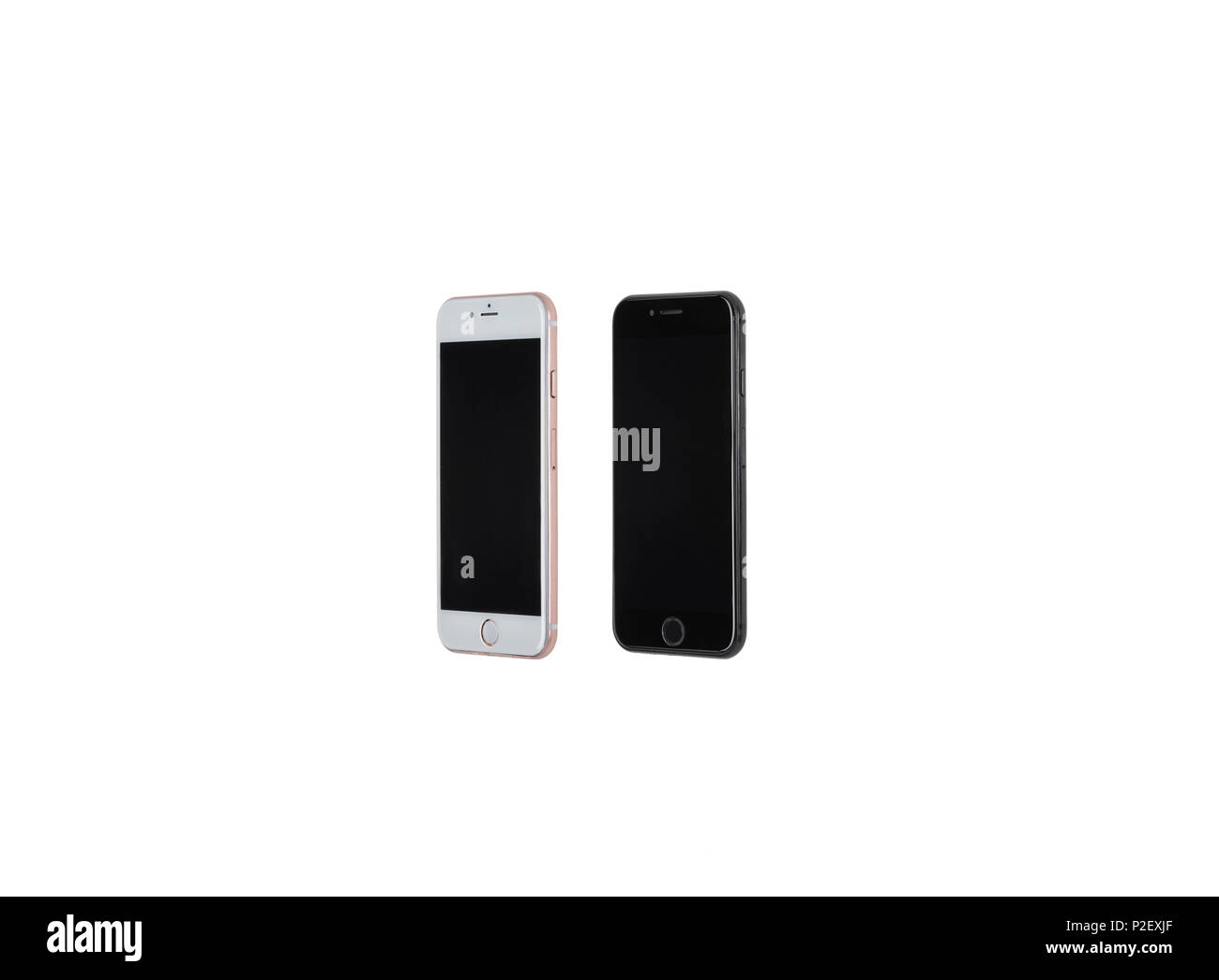 Close-up view of two smartphones with blank screens isolated on white ...