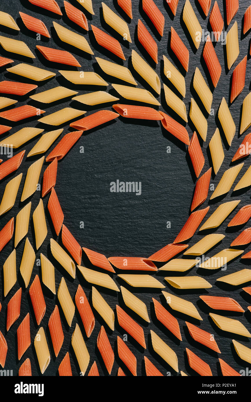 top view of circle frame made of pasta on black surface Stock Photo - Alamy
