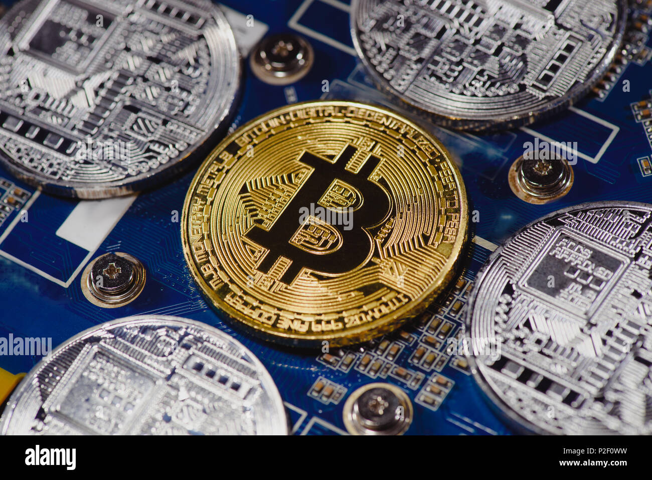 close up view of arranged golden and silver bit coins on computer ...