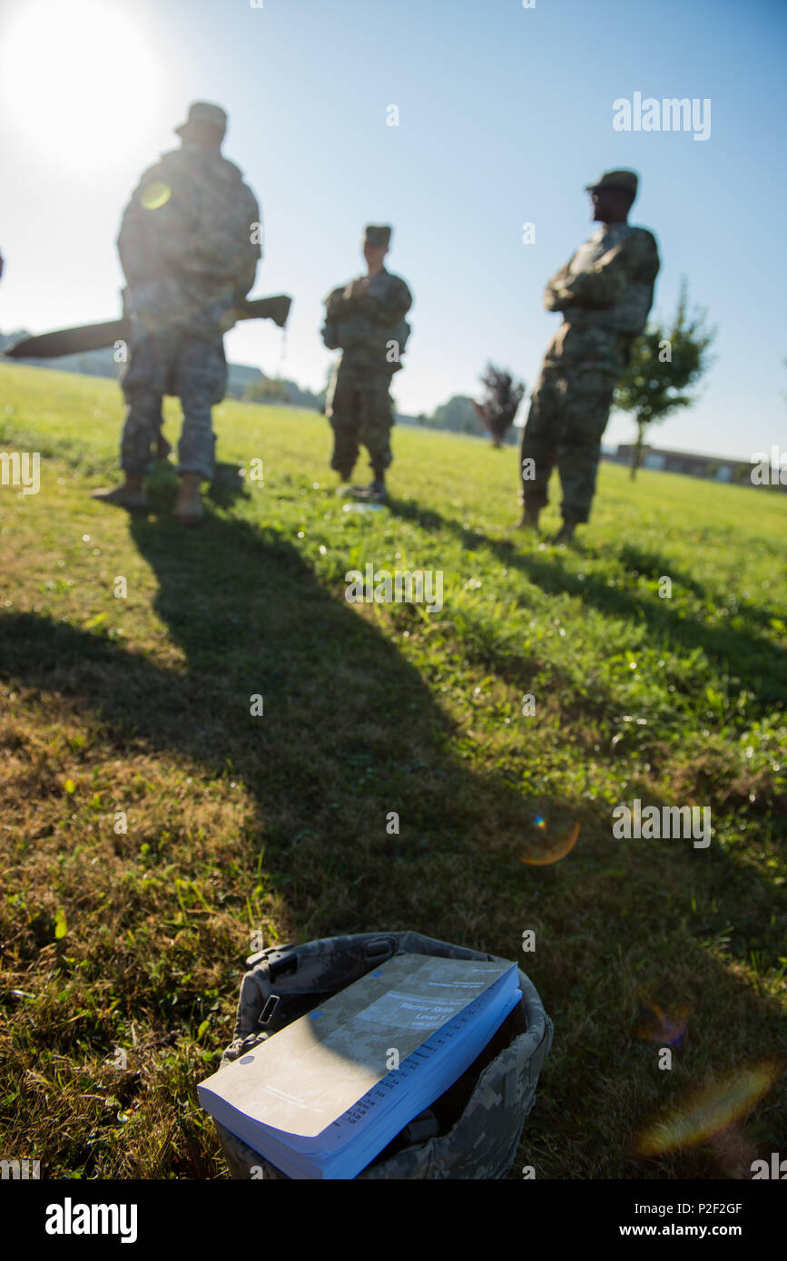 A Warrior Skills Level One manual lays atop a helmet, as U.S. Soldiers ...