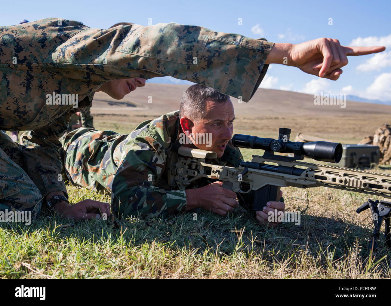 A U.S. Marine teaches a Bulgarian military member how to fire a sniper ...