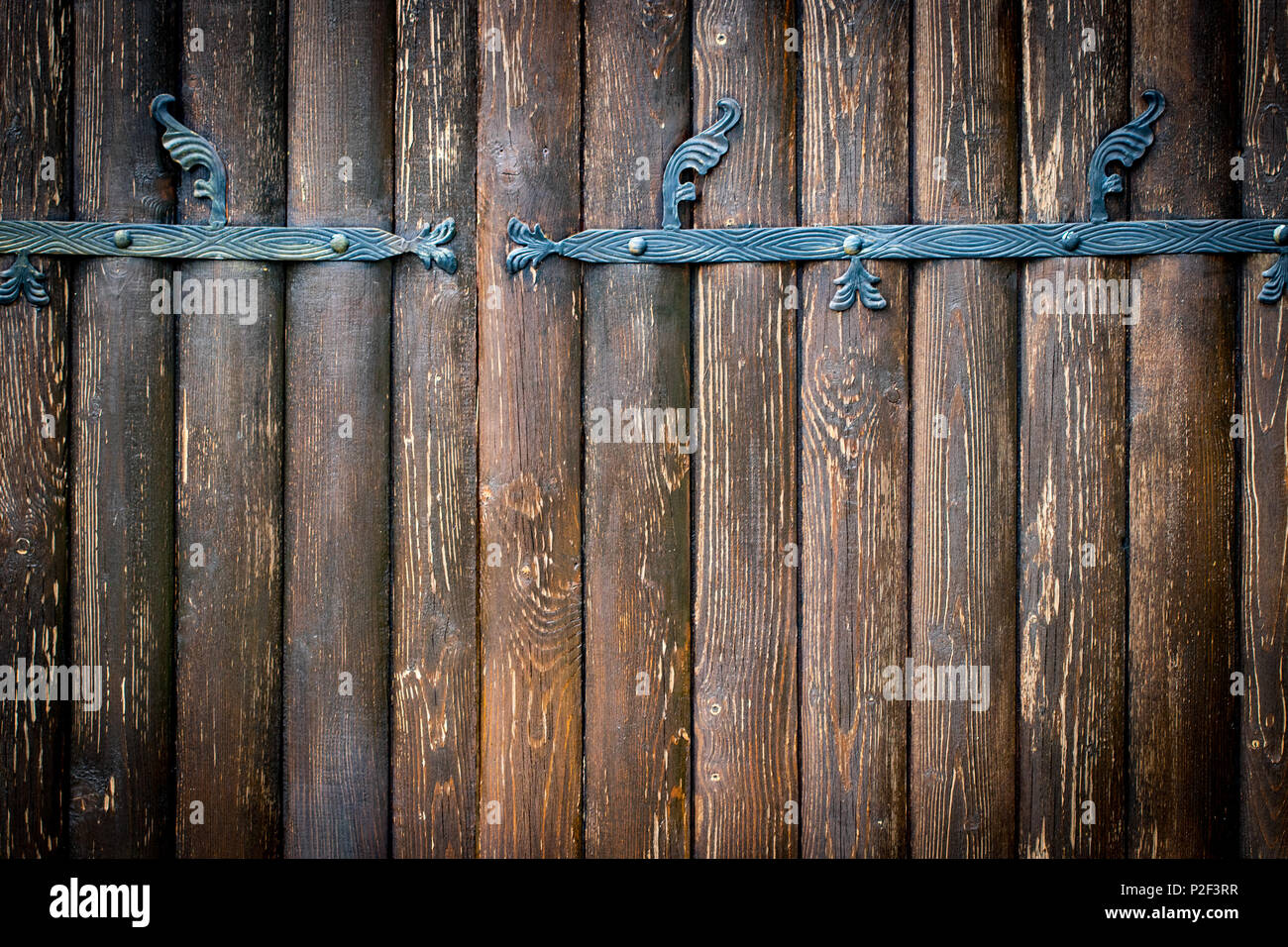 wooden gate with wrought iron elements close up Stock Photo - Alamy