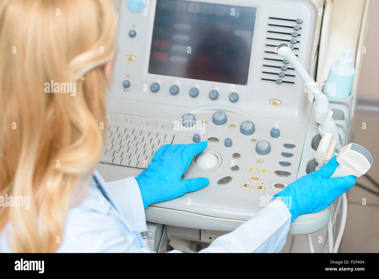 obstetrician gynecologist in gloves working with ultrasonic scanner ...