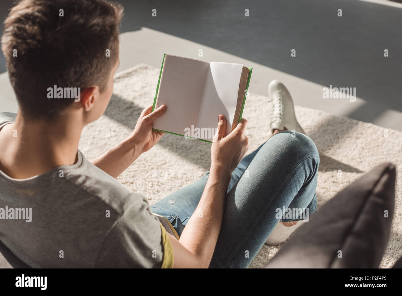 Rear view man reading book hi-res stock photography and images - Alamy
