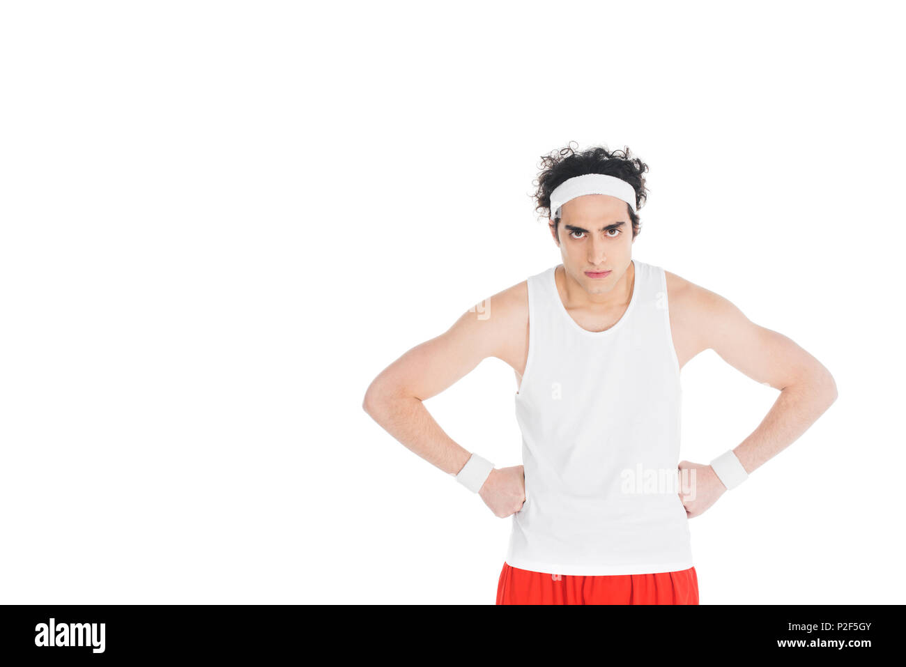 Thin serious sportsman with hands on waist isolated on white Stock ...