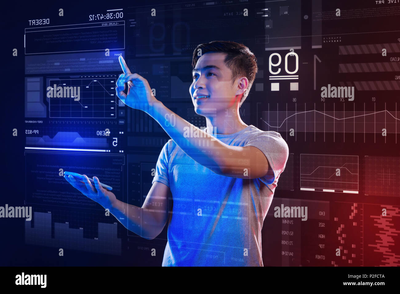 Positive web developer feeling excited while working with modern device ...