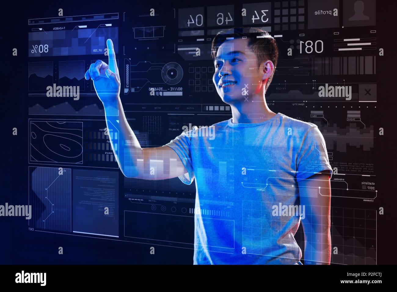Positive young programmer smiling and enjoying his work Stock Photo - Alamy Positive young programmer smiling and enjoying his work Stock Photo - Alamy
