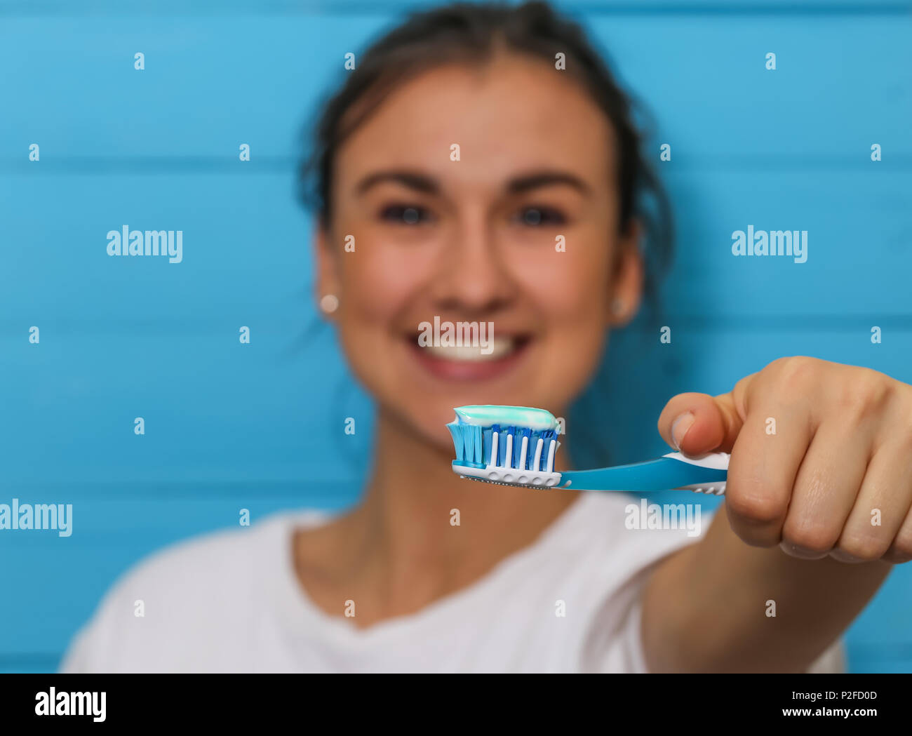 Beautiful young girl with a toothbrush and toothpaste on the beautiful ...
