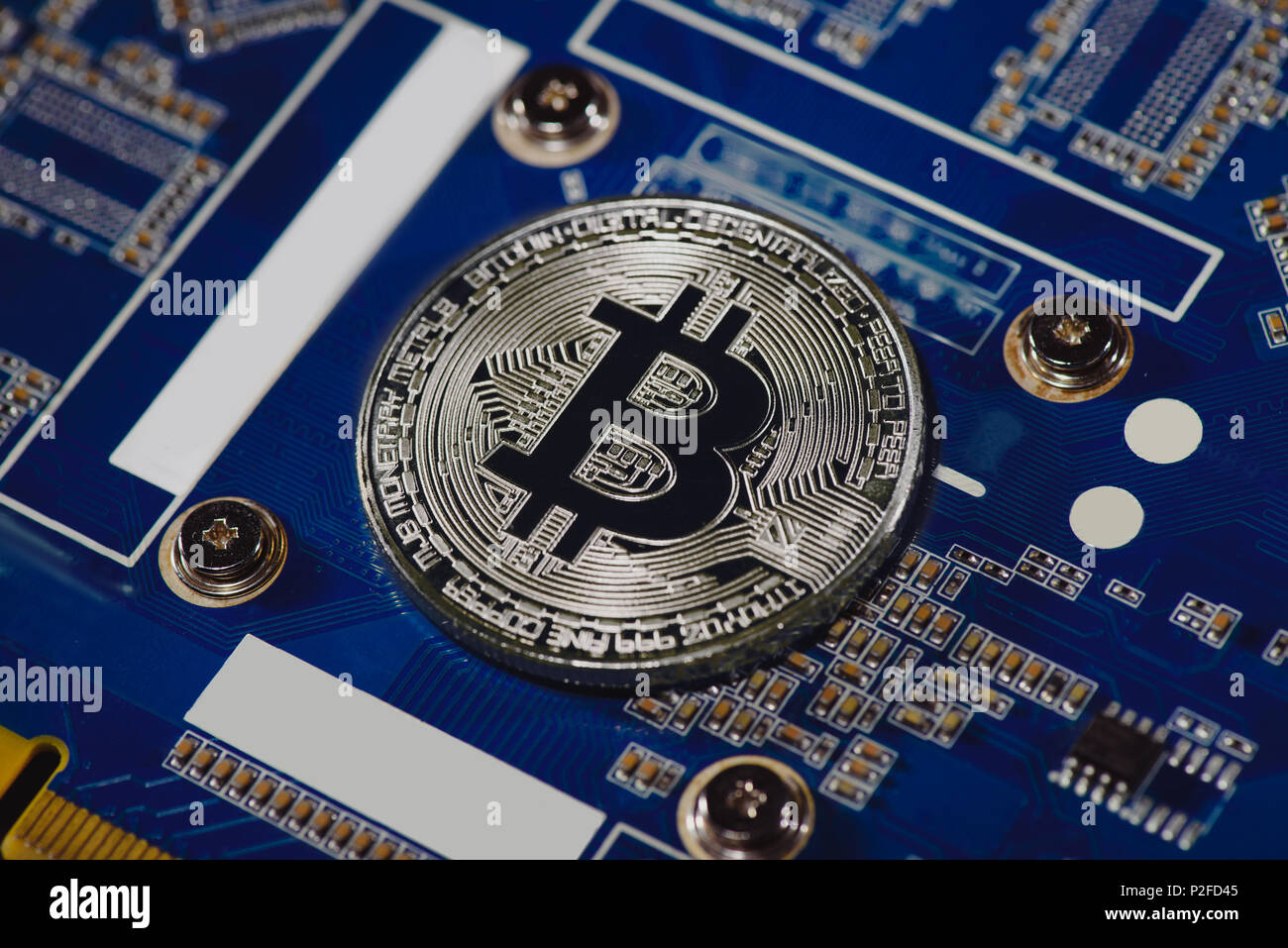 close up view of silver bit coin on computer motherboard Stock Photo ...