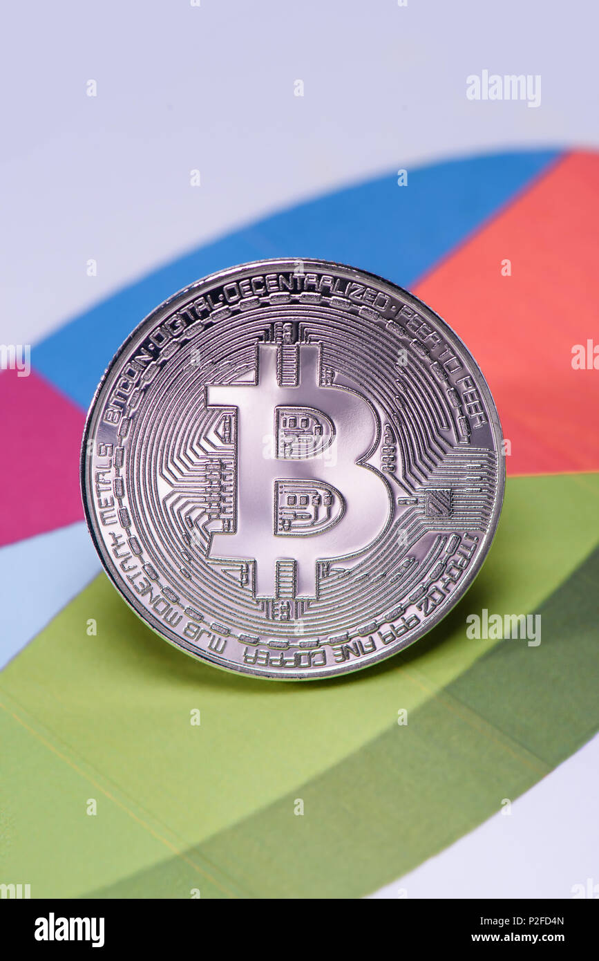 close up view of silver bit coin on colorful diagram Stock Photo - Alamy