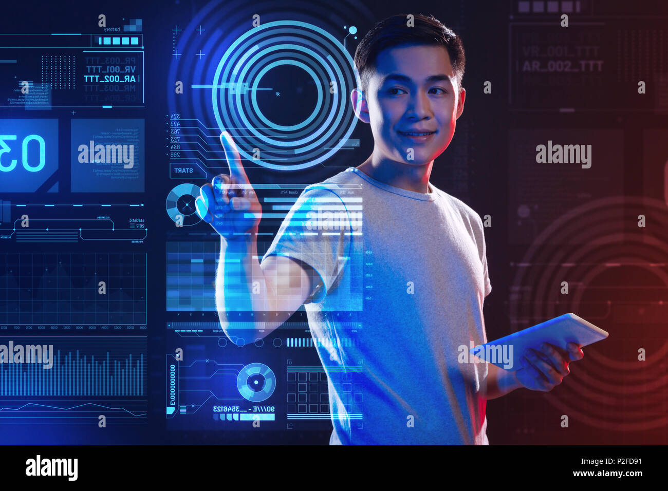 Cheerful web developer using holograms and enjoying his work Stock ...