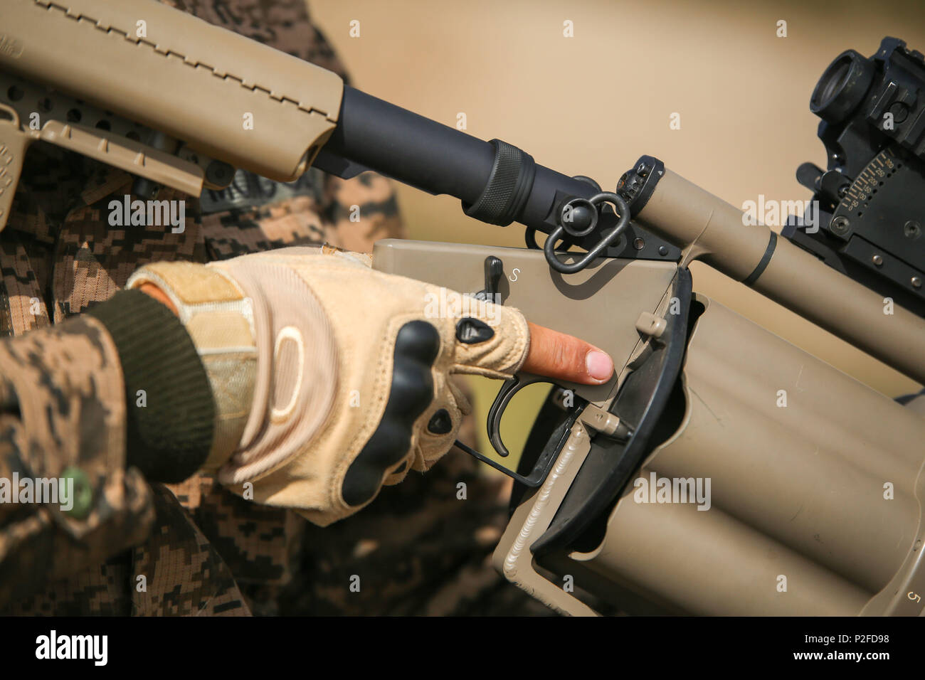 A Mongolian Armed Forces soldier keeps his finger straight and of the ...