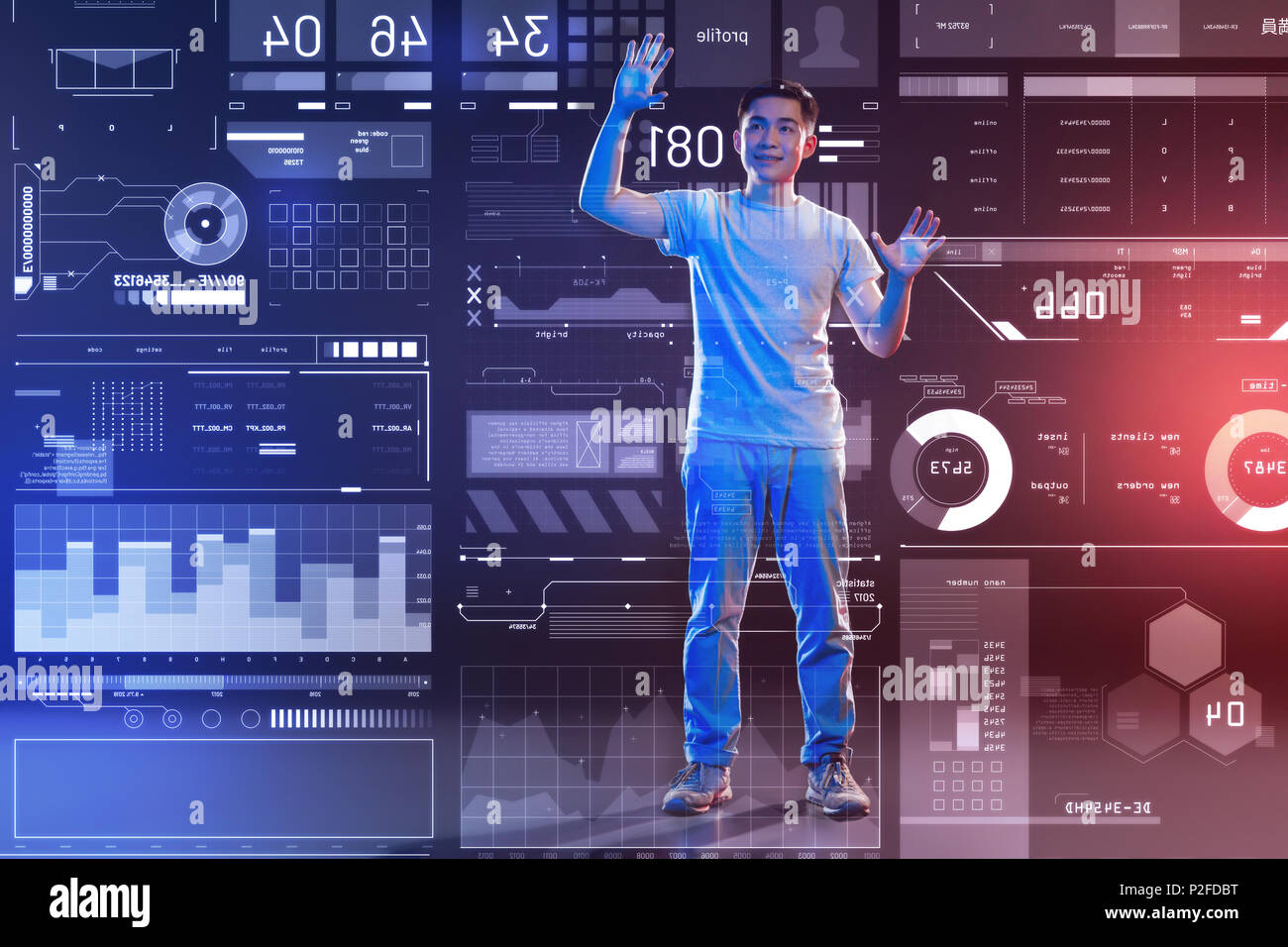 Positive web developer smiling and touching the transparent screen ... Positive web developer smiling and touching the transparent screen ...
