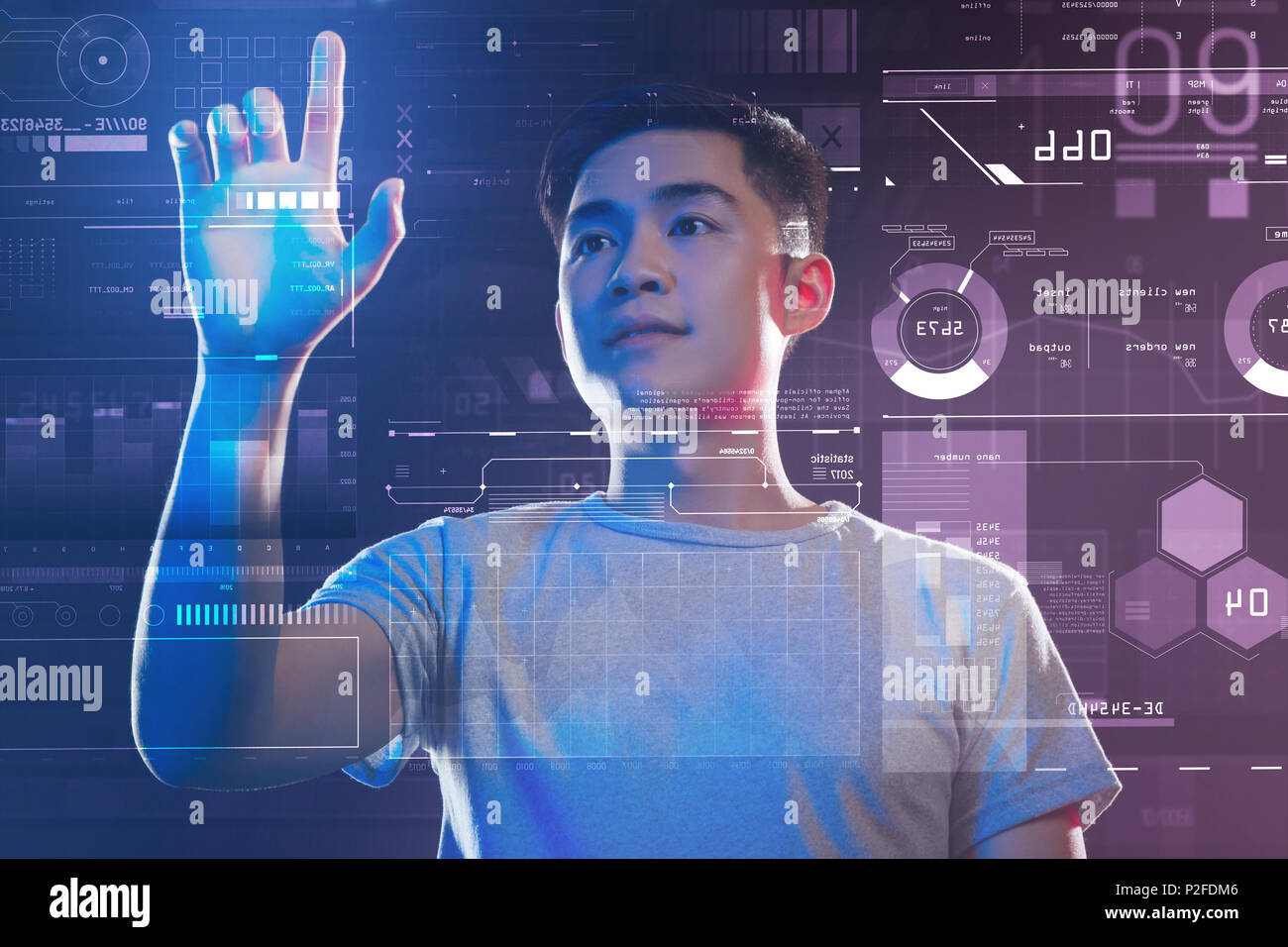 Experienced programmer working in his modern office and touching a device Stock Photo - Alamy