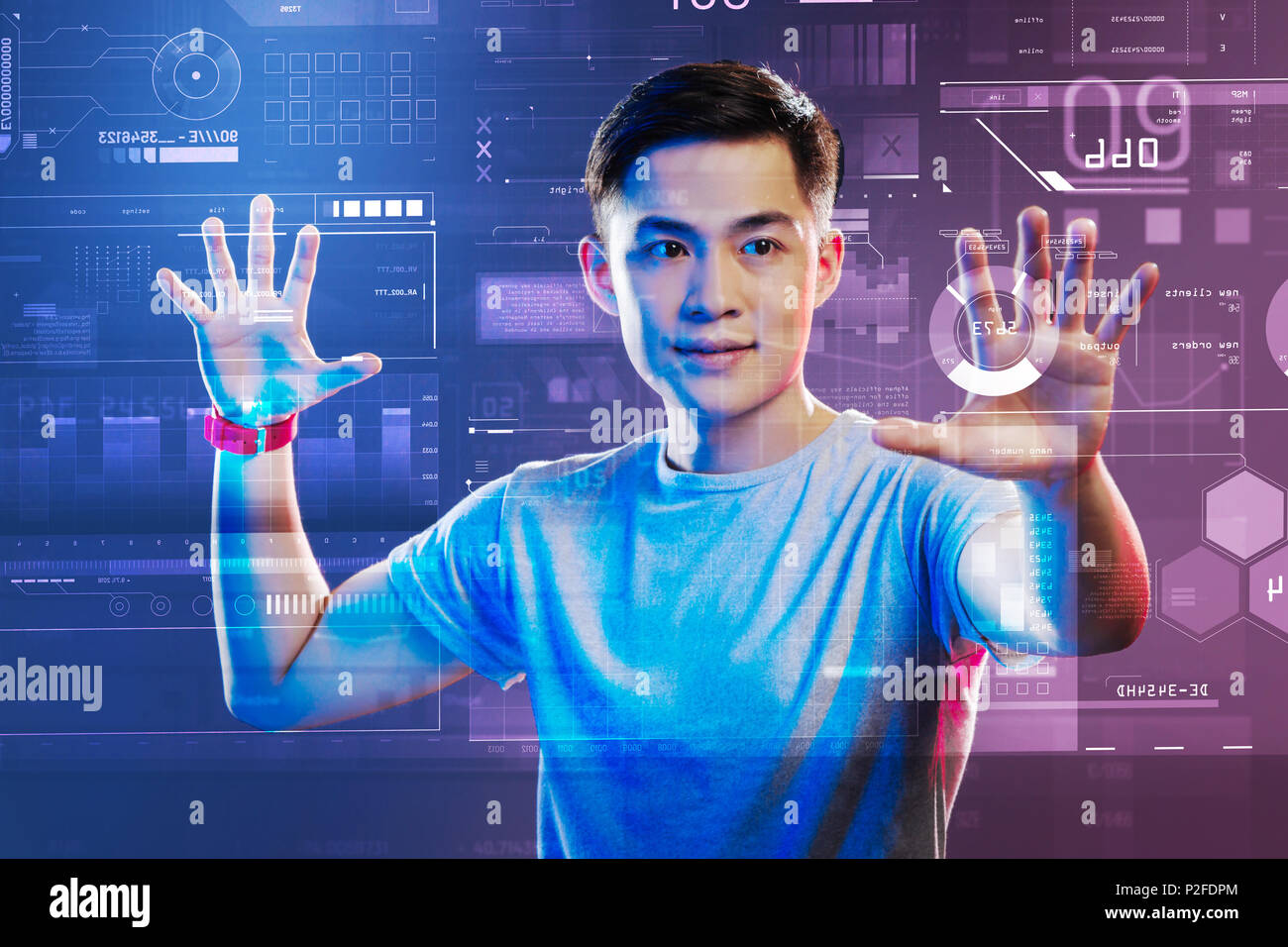 Professional web developer working with holographic images and looking ...