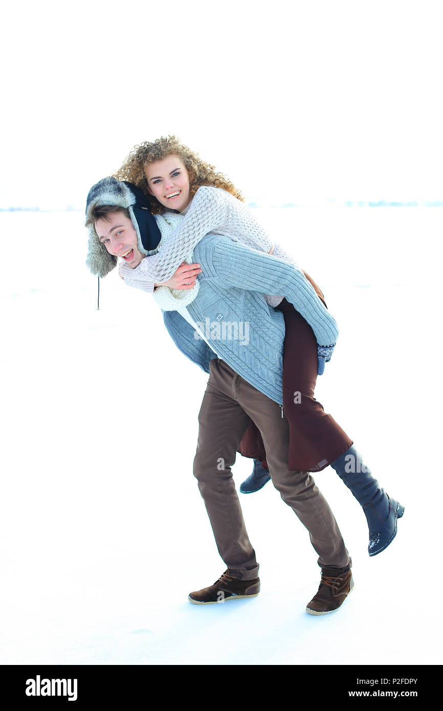 Man picking up woman in white monophonic background Stock Photo - Alamy