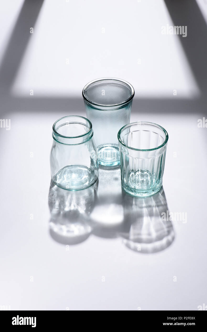 close up view of empty glassware on white surface Stock Photo - Alamy