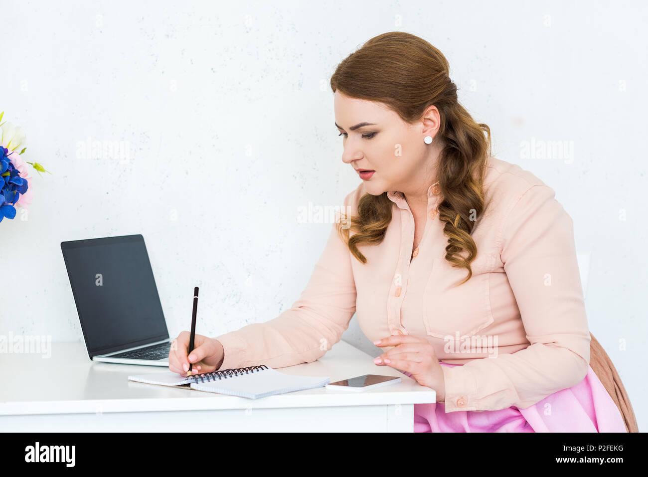 beautiful woman writing something to notebook in kitchen Stock Photo ...