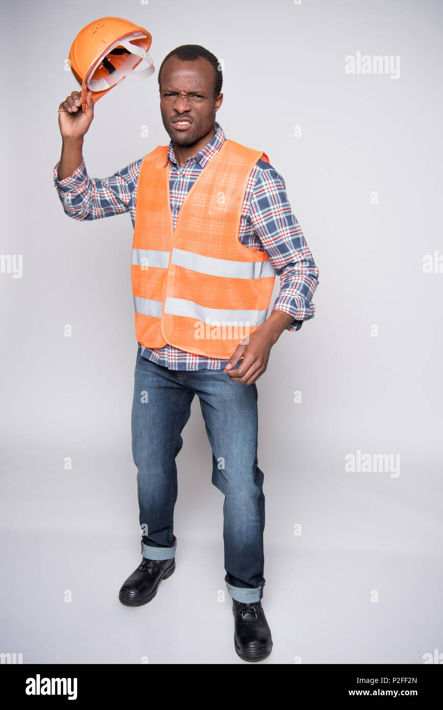 Full-length shot of angry construction worker in a vest throwing his ...