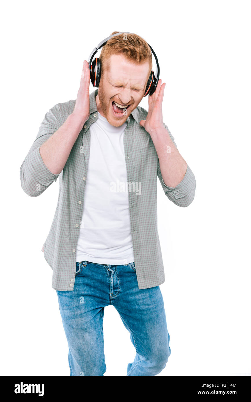 upset man screaming and listening music with headphones, isolated on ...