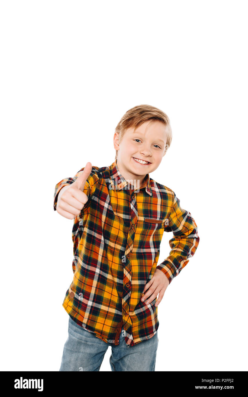 cheerful little boy showing thumb up and smiling at camera isolated on ...