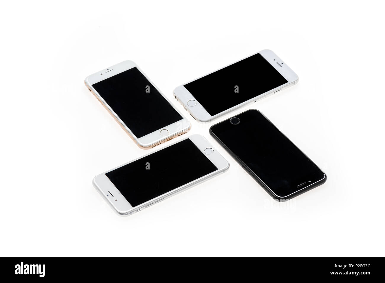 four smartphones with blank screens isolated on white, communication ...