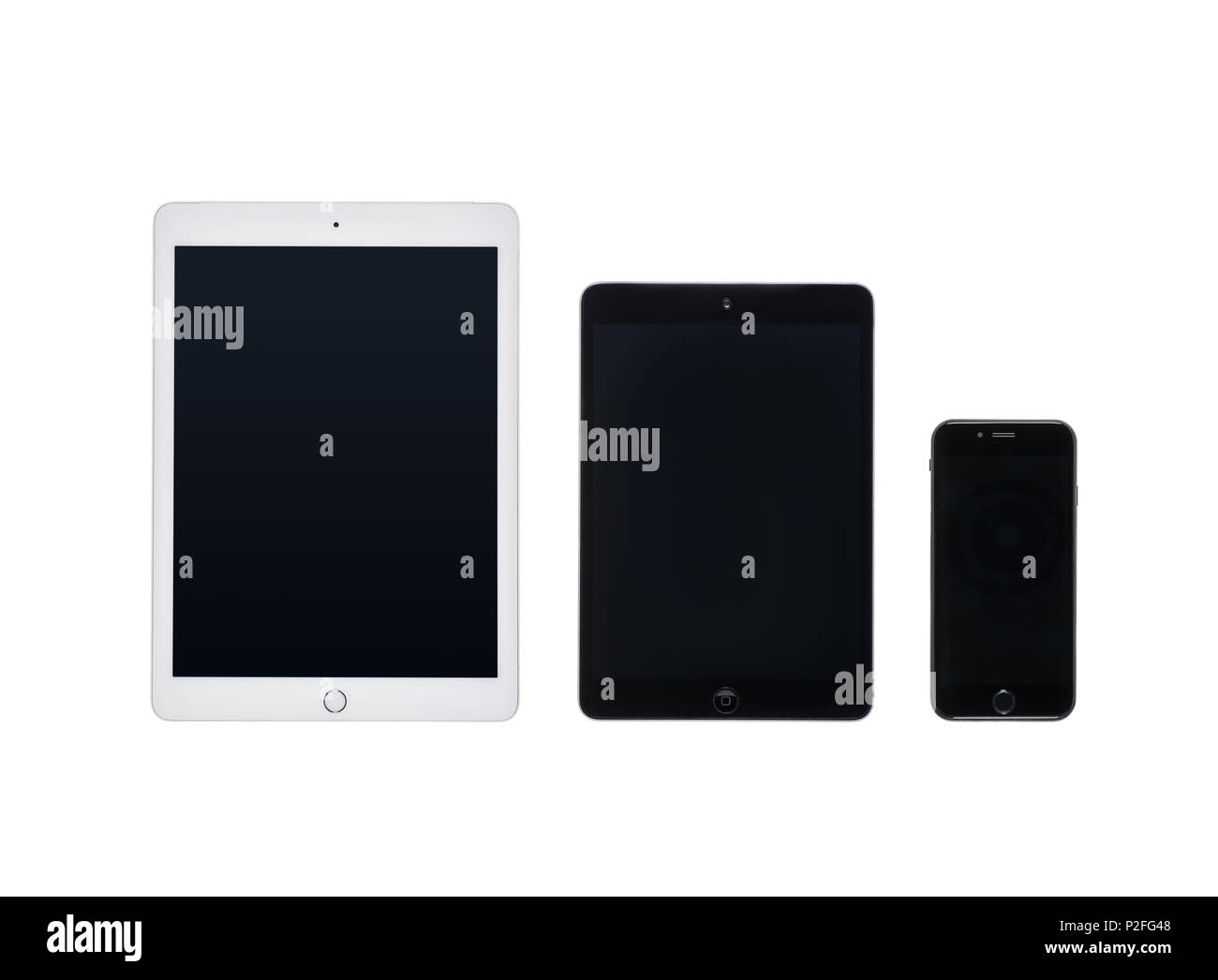 Close-up view of two digital tablets and smartphone with black screens ...