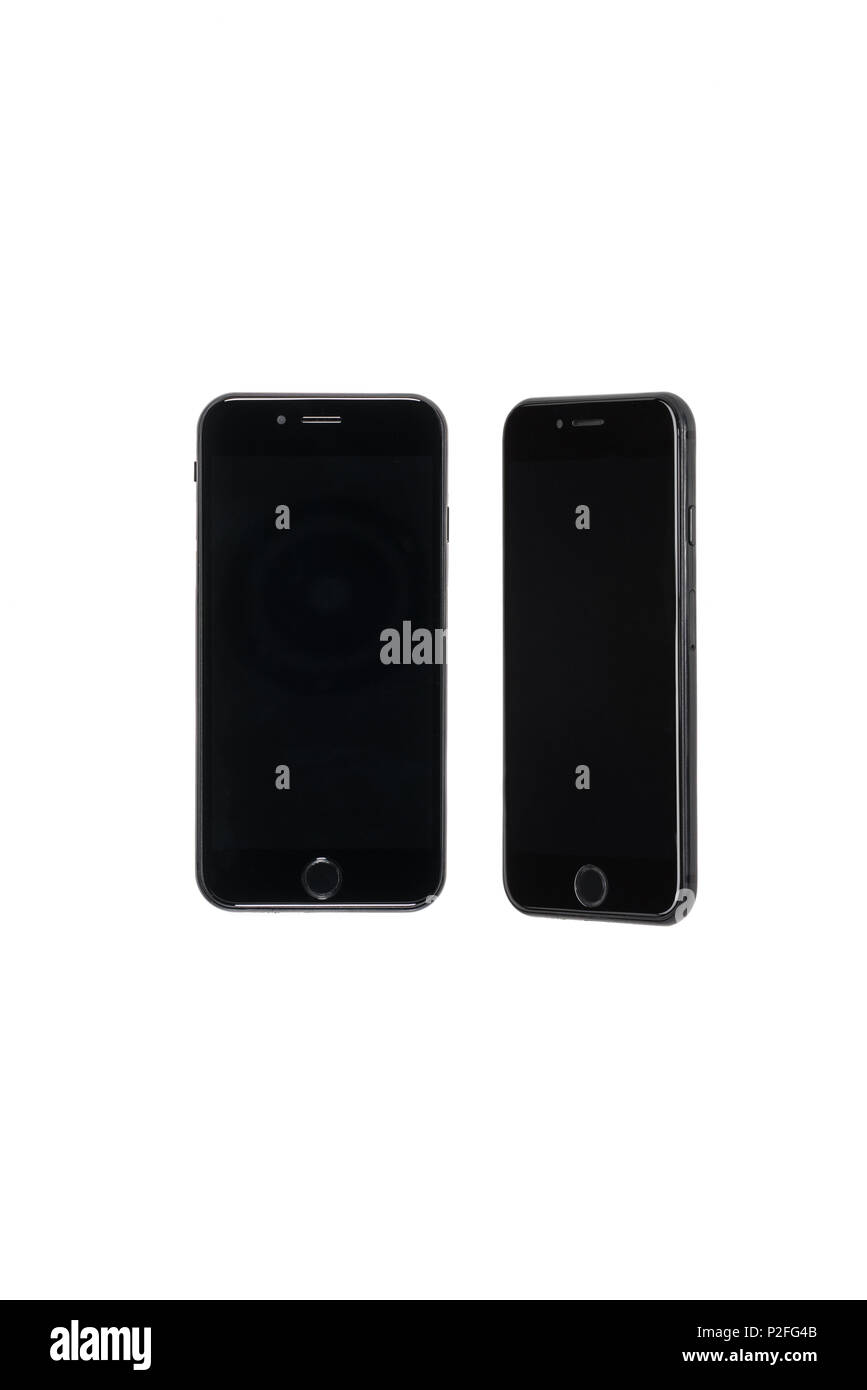 Close-up view of two smartphones with blank screens isolated on white ...