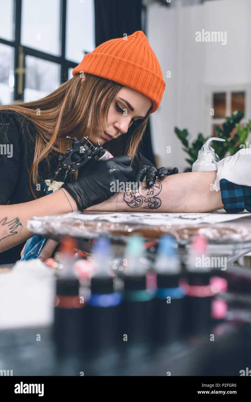 Professional tattoo artist creating on hi-res stock photography and ...