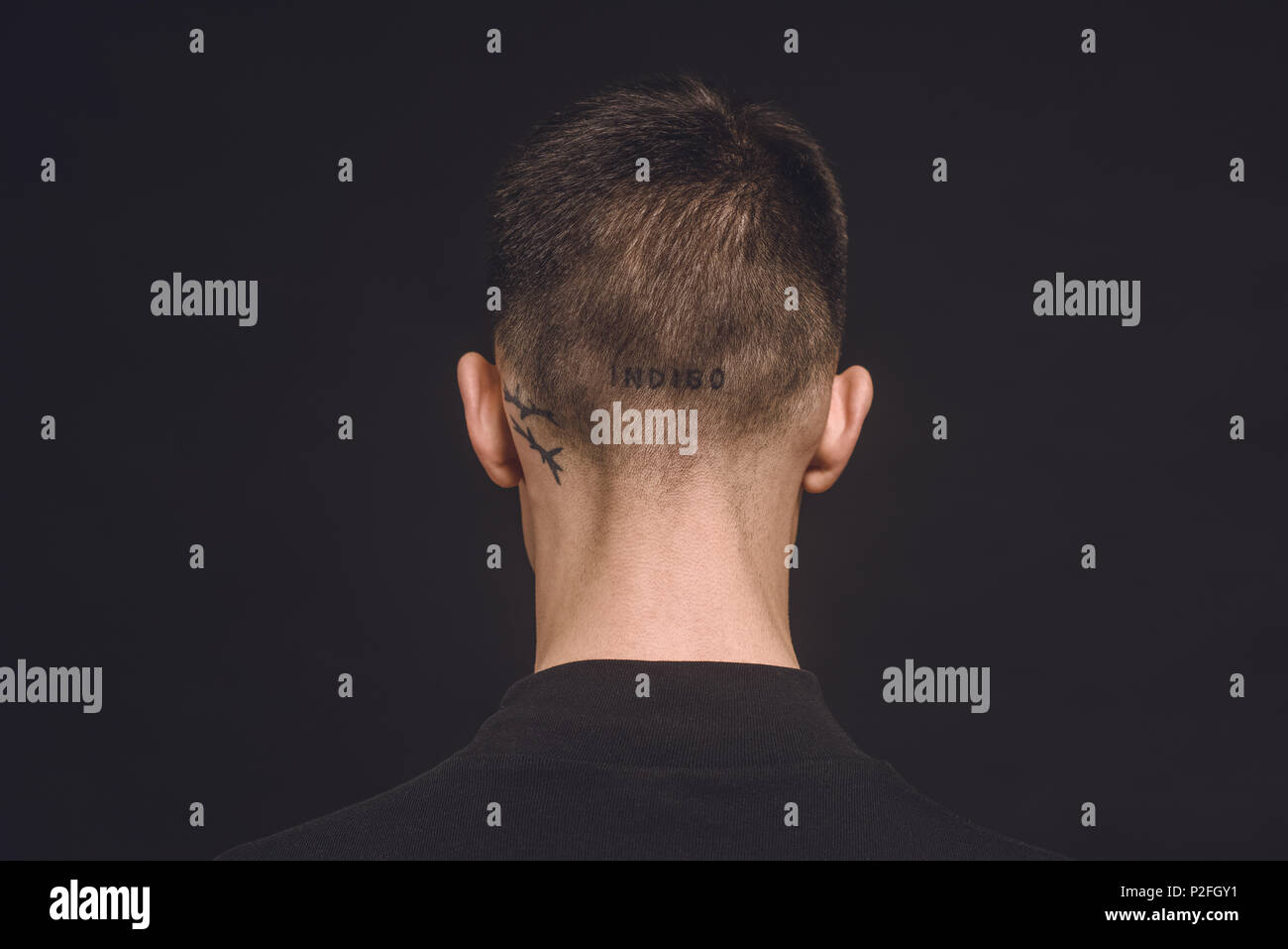 Rear view of tattoos on male neck isolated on black Stock Photo - Alamy