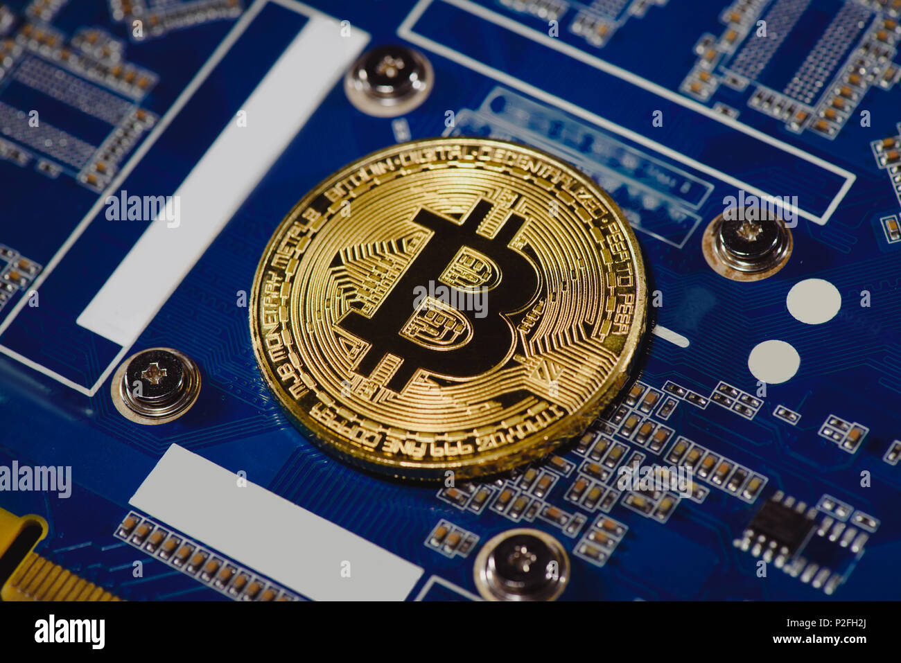 close up view of golden bit coin on computer motherboard Stock Photo ...