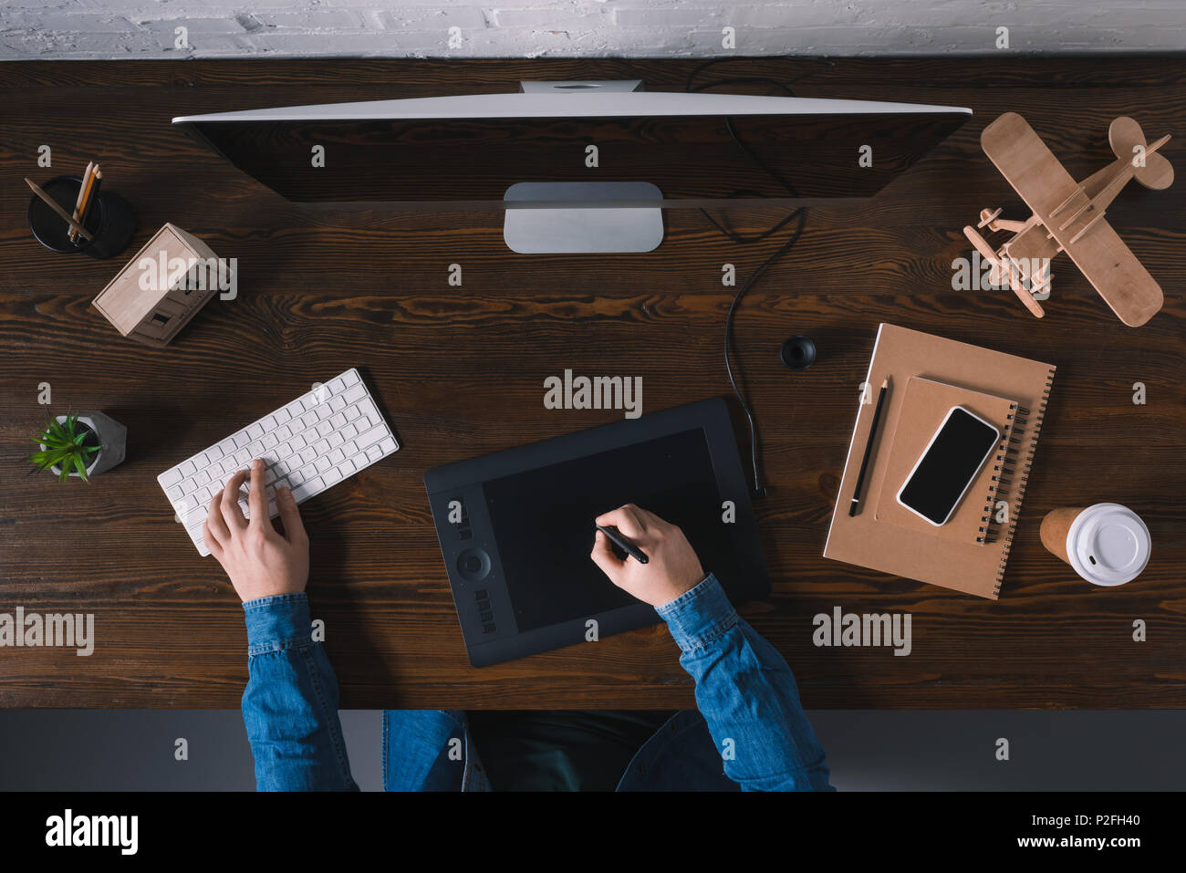top view of person using graphics tablet and typing on keyboard at workplace Stock Photo - Alamy