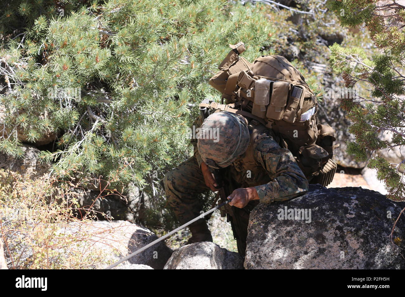 Lance Cpl. Brandon Lopez-Guzman climbs up the rock face while being ...