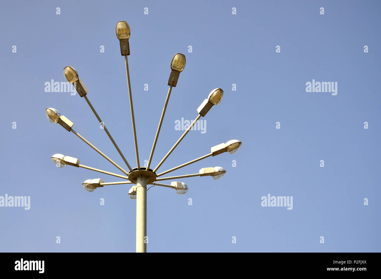 A street lamp consisting of a high pillar and a number of plafonds for ...