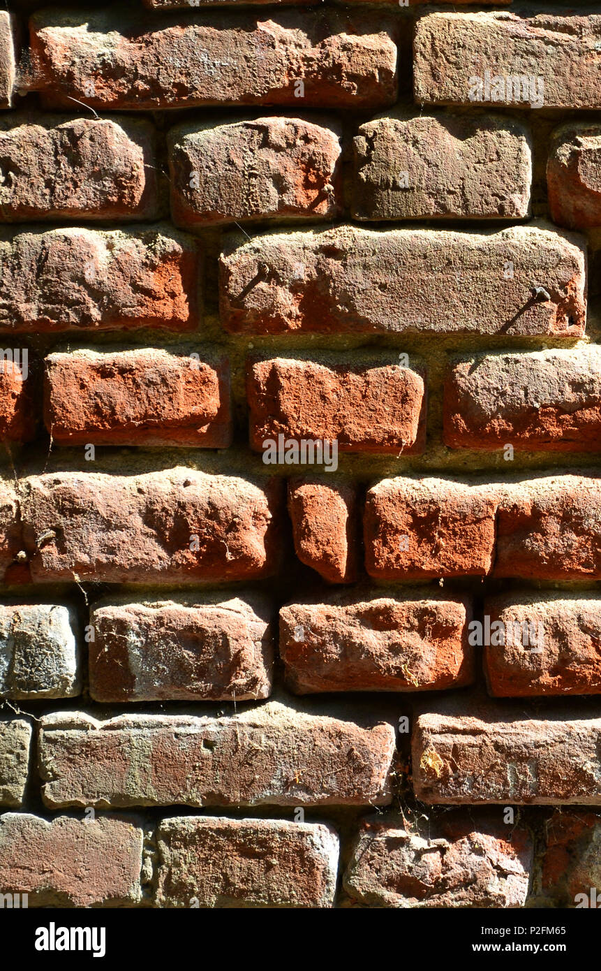 Vertical wall texture of several rows of very old brickwork made of red ...