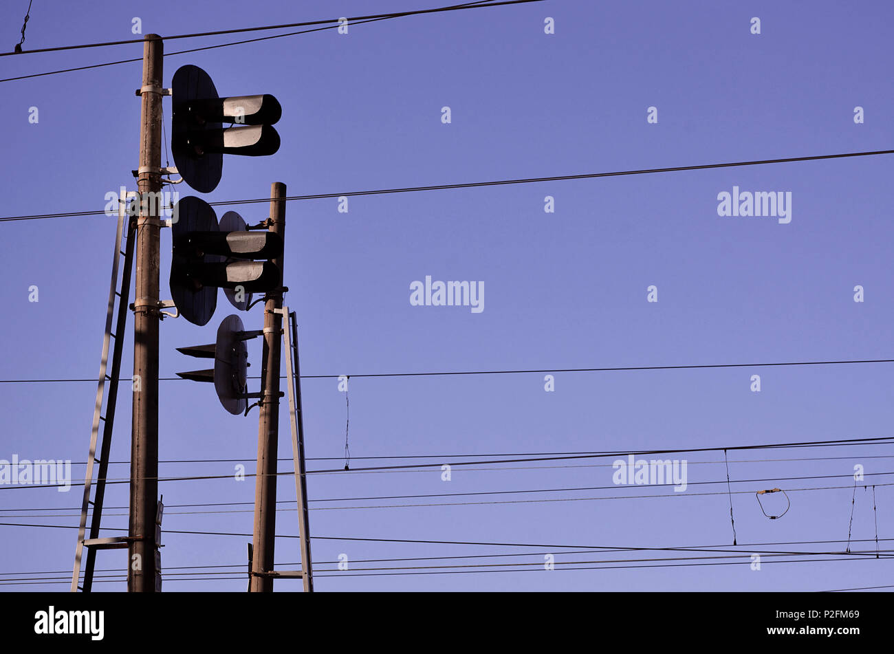 Railroad traffic light against clear blue sky, Contact wire. High ...