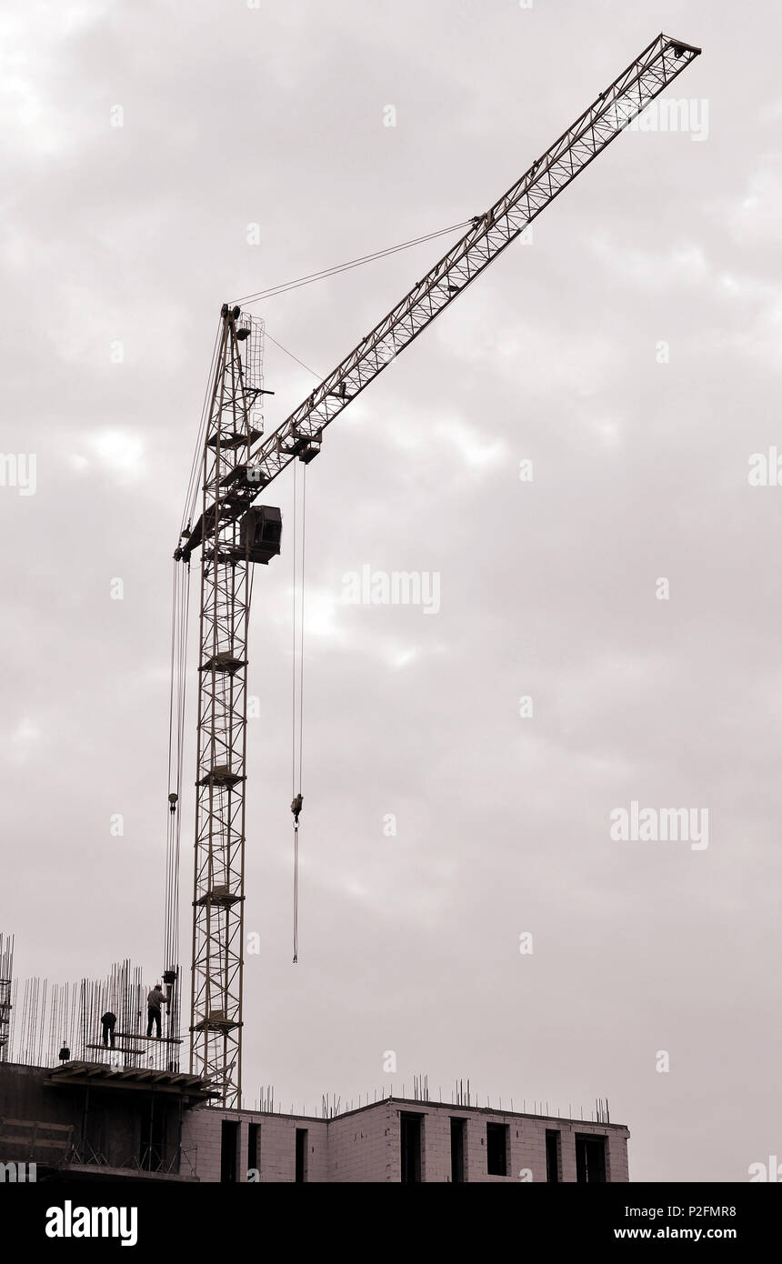 Working tall cranes inside place for with tall buildings under ...