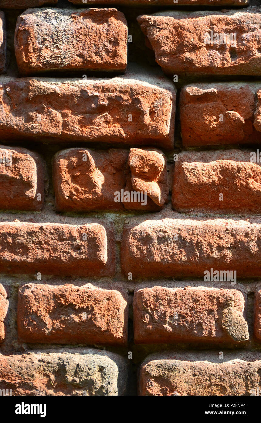 Vertical wall texture of several rows of very old brickwork made of red ...