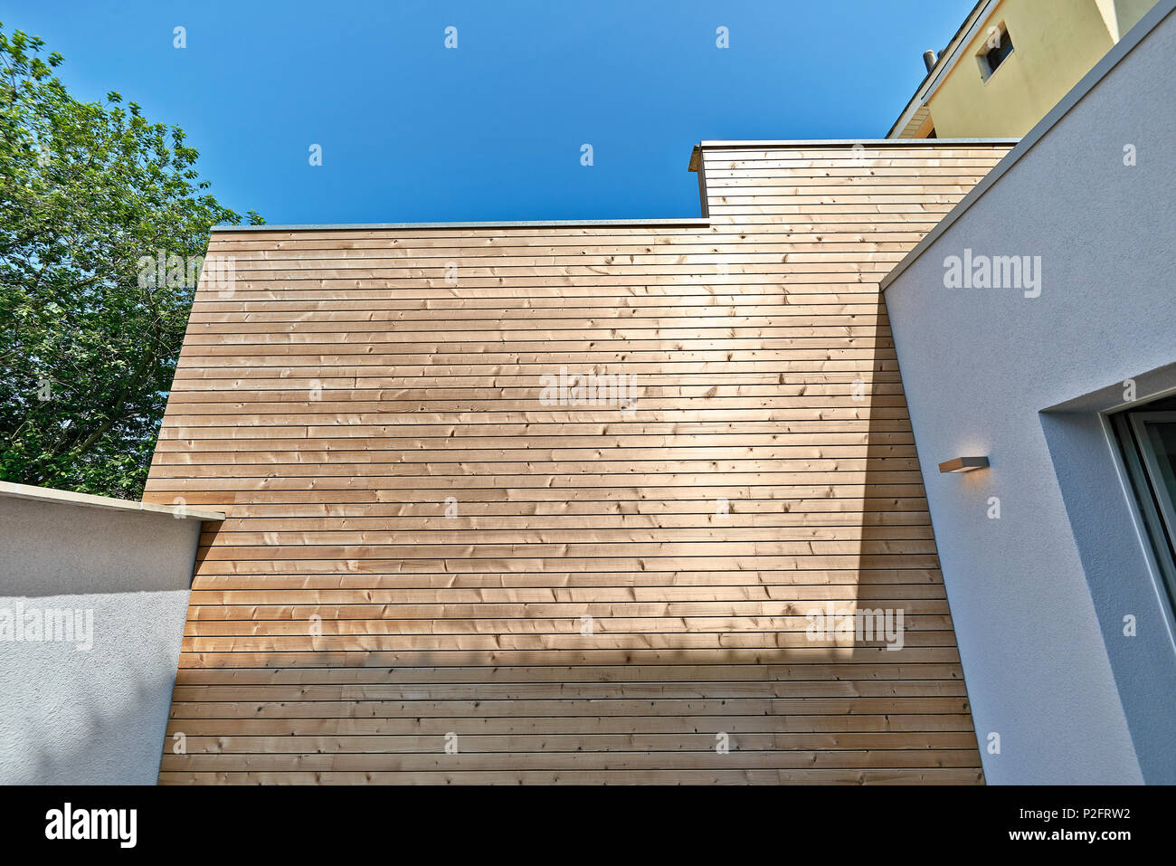 Renovated white ciment wall and insulating wood cladding in outdoor ...