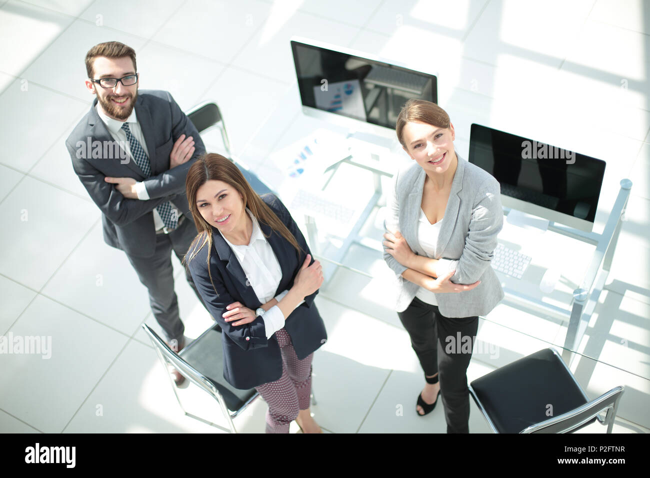 top view. three employees standing in the office Stock Photo - Alamy