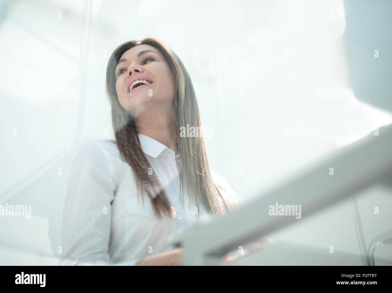 through the glass.thoughtful business woman sitting at the Desk Stock ...