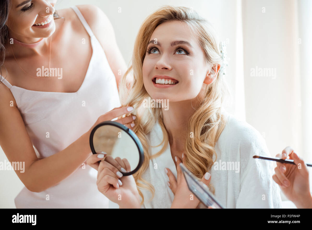 beautiful young bride getting makeup before wedding and looking up ...
