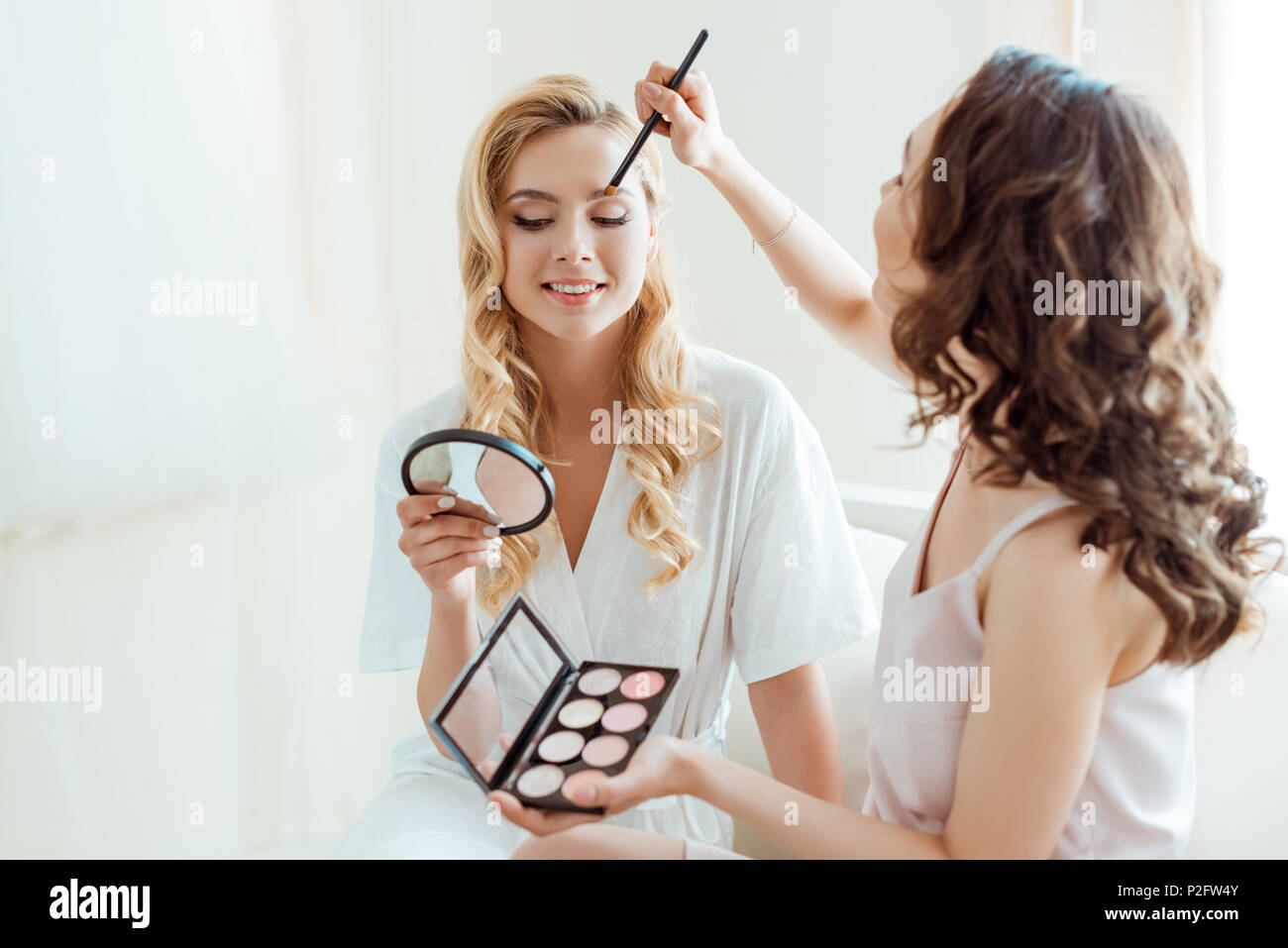 beautiful young bride getting makeup before wedding Stock Photo - Alamy