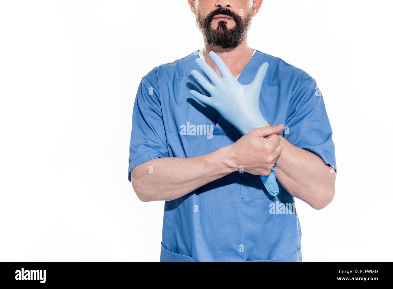cropped shot of bearded middle aged doctor wearing medical gloves ...