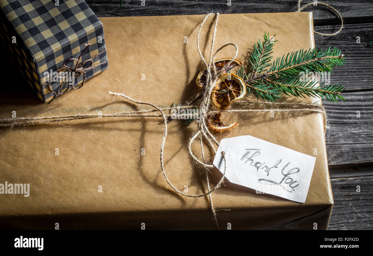 Packed box, beautifully wrapped gift on a wooden background with the ...