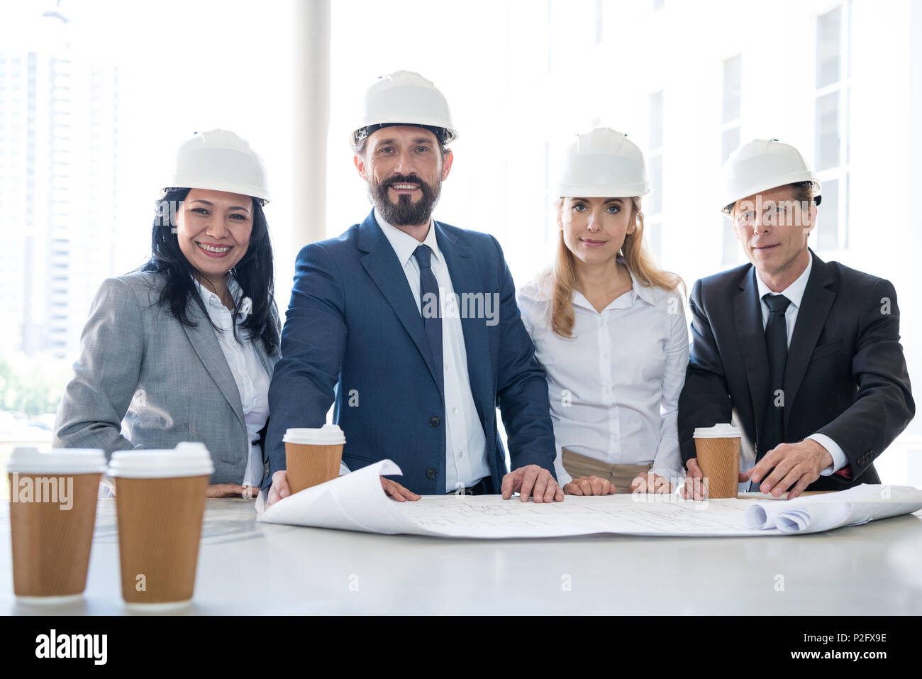 smiling multiethnic architects in formal wear looking at camera Stock ...